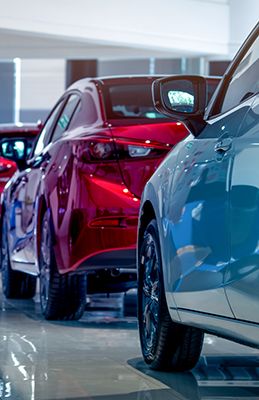 Three cars, one parked in front of the other.